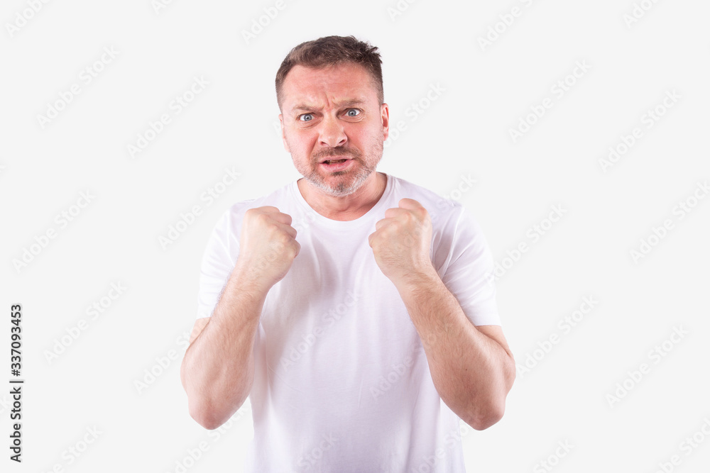 Angry man, hands clenched into fists, teeth clenched. Isolated, white ...