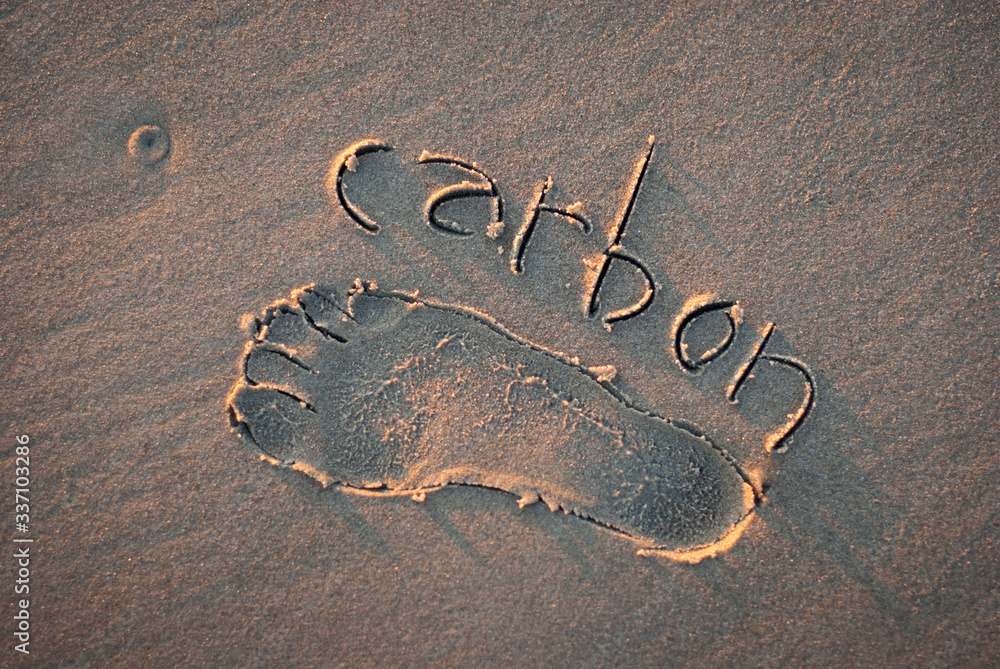 Eco-friendly carbon footprint message handwritten with the outline of a ...