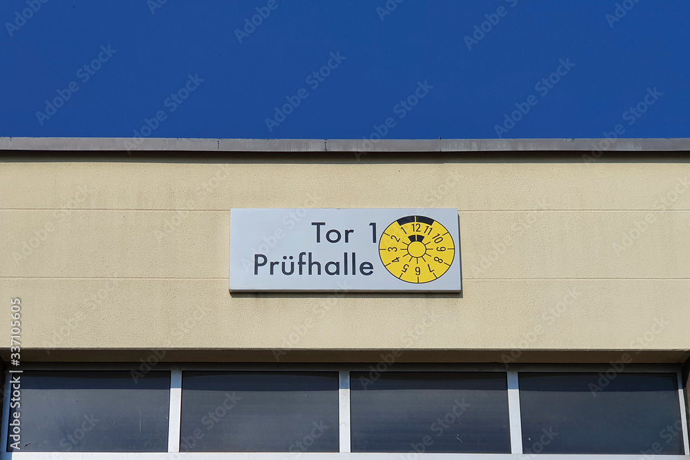 Gate to a technical test center for vehicles with the symbol of a ...