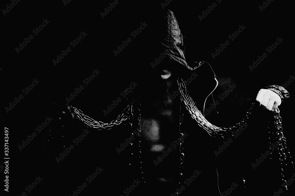 Boxer in a corner with a chain on his back and pumped body. Beauty and ...