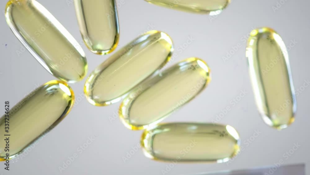 Omega 3 gold fish oil capsules, rotation background. Capsules isolated ...