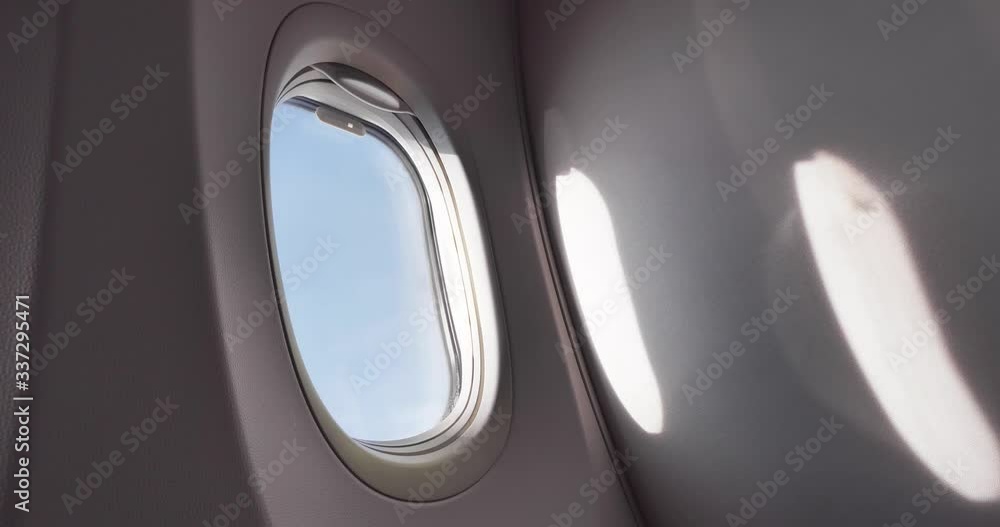 Plane is flying a curve and lights are moving through window of ...