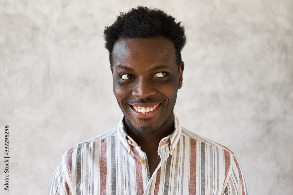 Isolated shot of funny attractive young African male in casual shirt ...