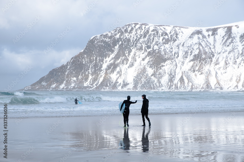 Surfing in cold ocean in Lofoten islands. Famous destination for ...