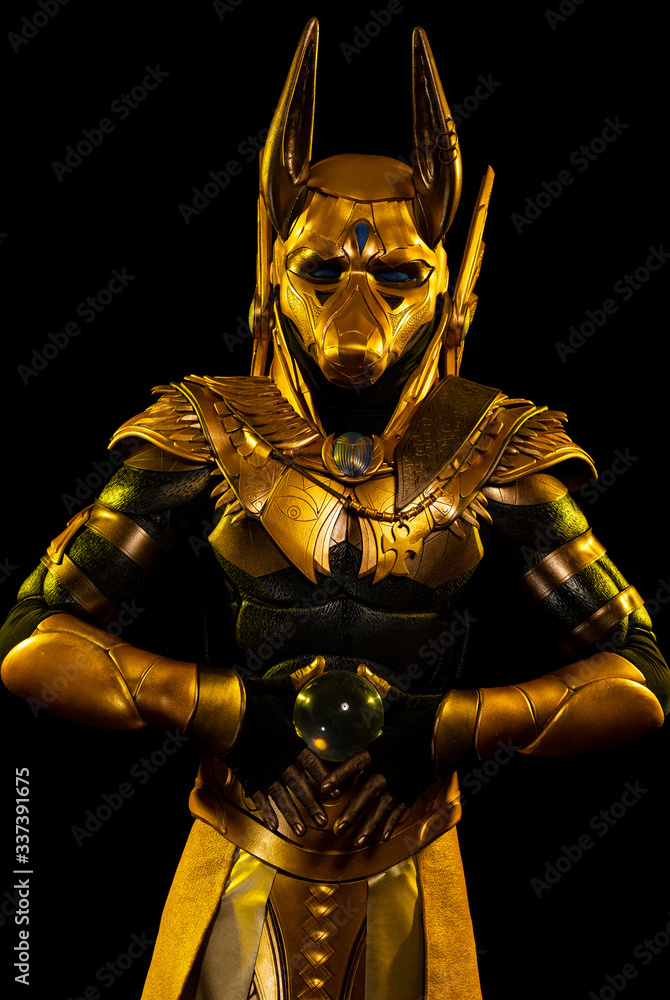 a male actor in a suit of an Egyptian mythology character, the golden ...