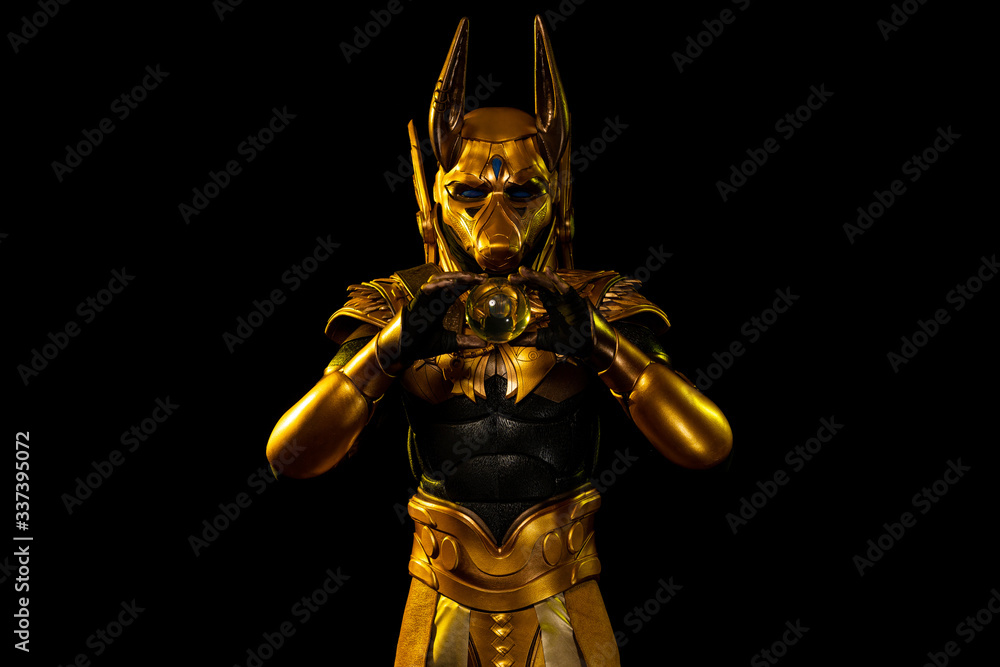 a male actor in a suit of an Egyptian mythology character, the golden ...