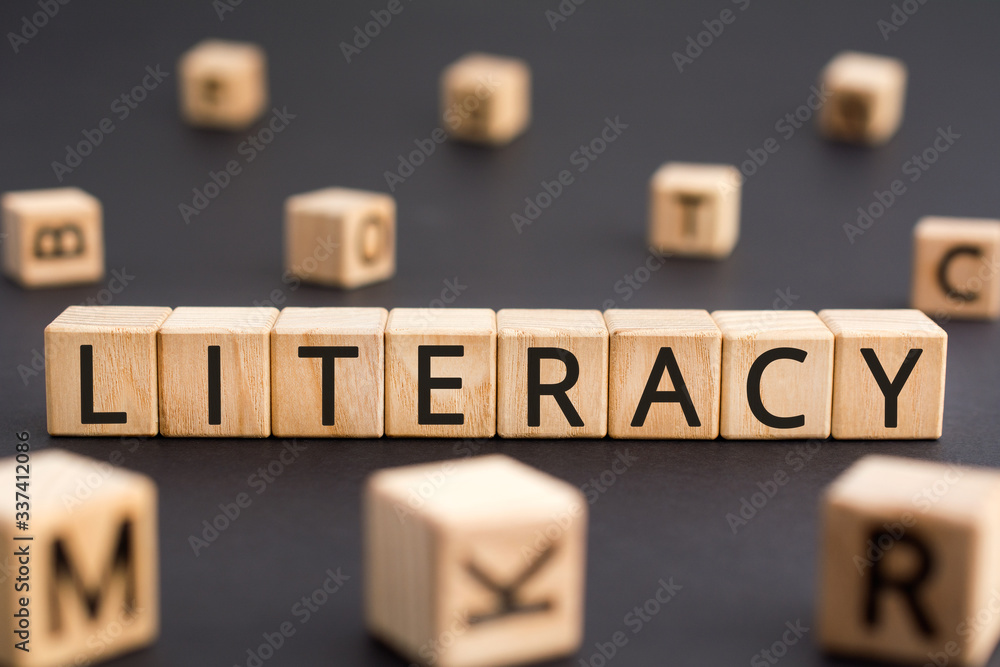 Literacy - word from wooden blocks with letters, literacy the ability ...