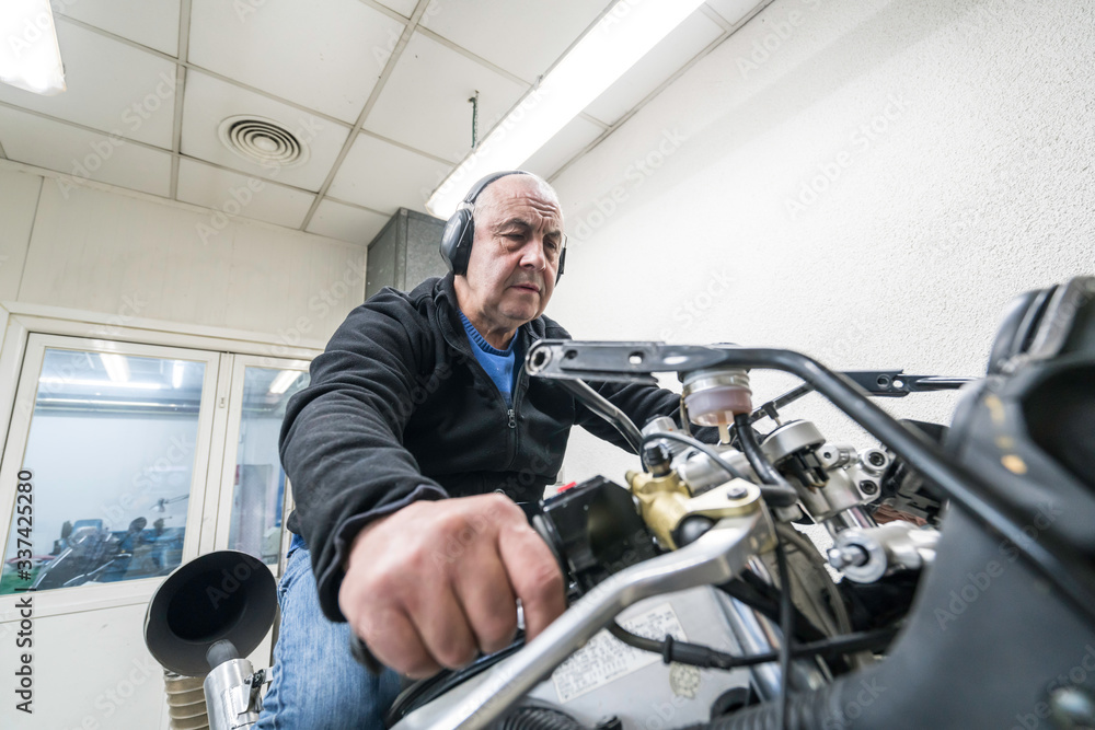 Engineer testing power of a motorcycle by dyno. Racing Motorcycle Stock ...