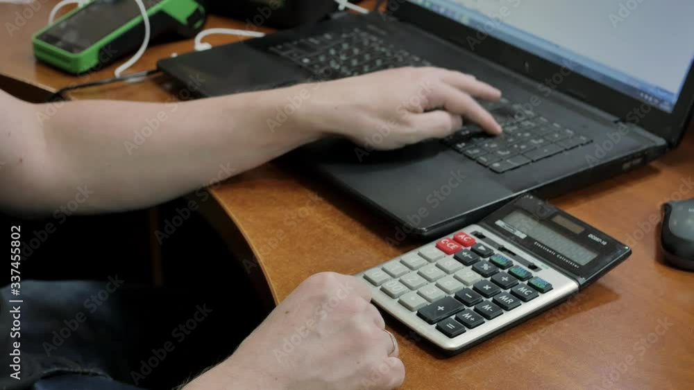 The accountant at home at the computer counts the numbers on the ...