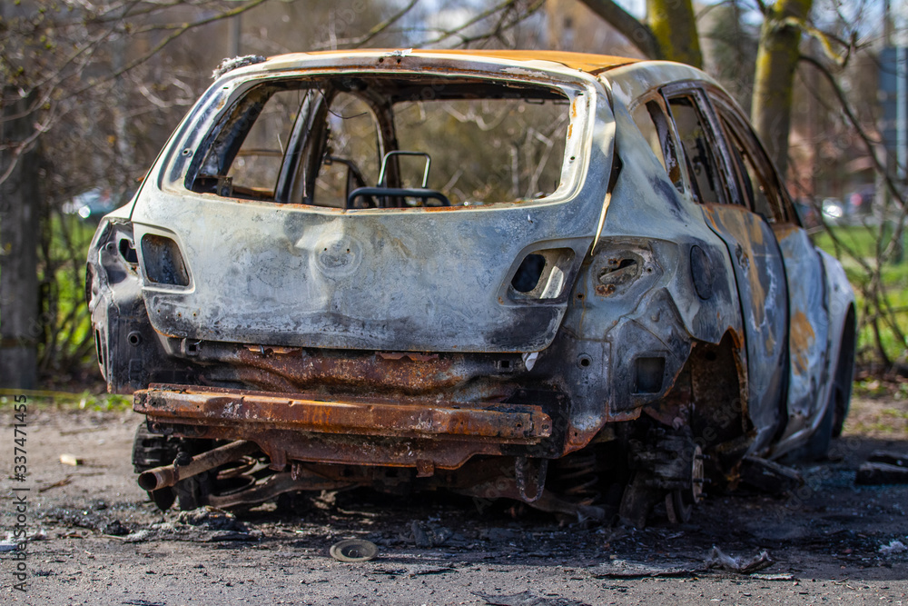 Burned car, burned-out car body. Road wreck accident or arson fire ...