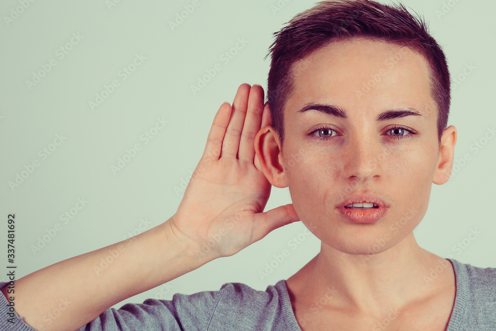 Closeup portrait young nosy woman hand to ear gesture carefully ...