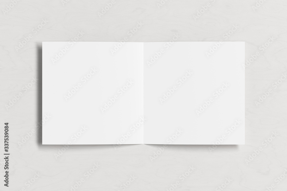 Blank square pages leaflet on white wooden background. Bi-fold or half ...