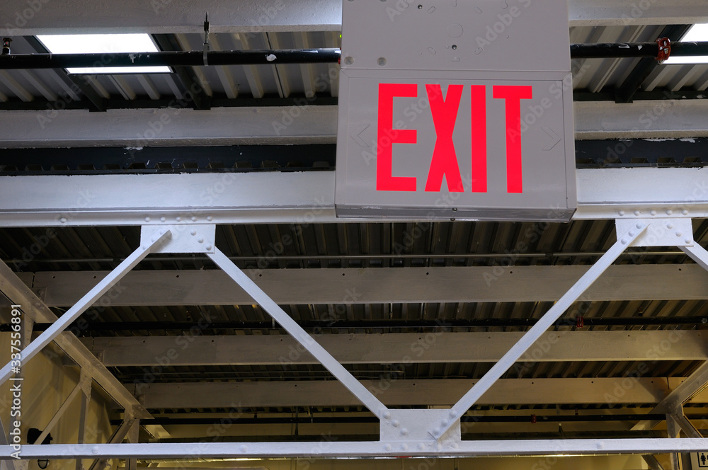 Exit sign on ceiling with steel roof girders and skylights Stock Photo ...