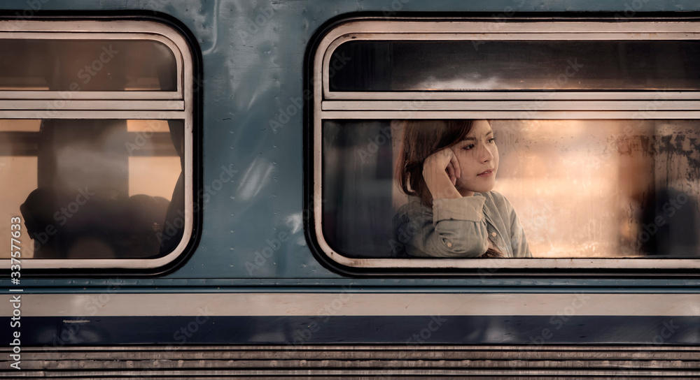 young asian woman looking through the train window. Stock Photo | Adobe ...