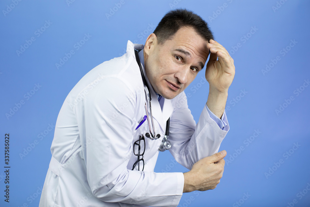 Middle aged handsome doctor in white coat and stethoscope hiding with ...