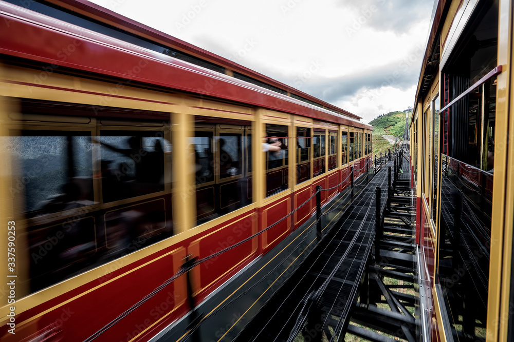 Aerial view of Red tram retro style run to the top hill with passenger ...