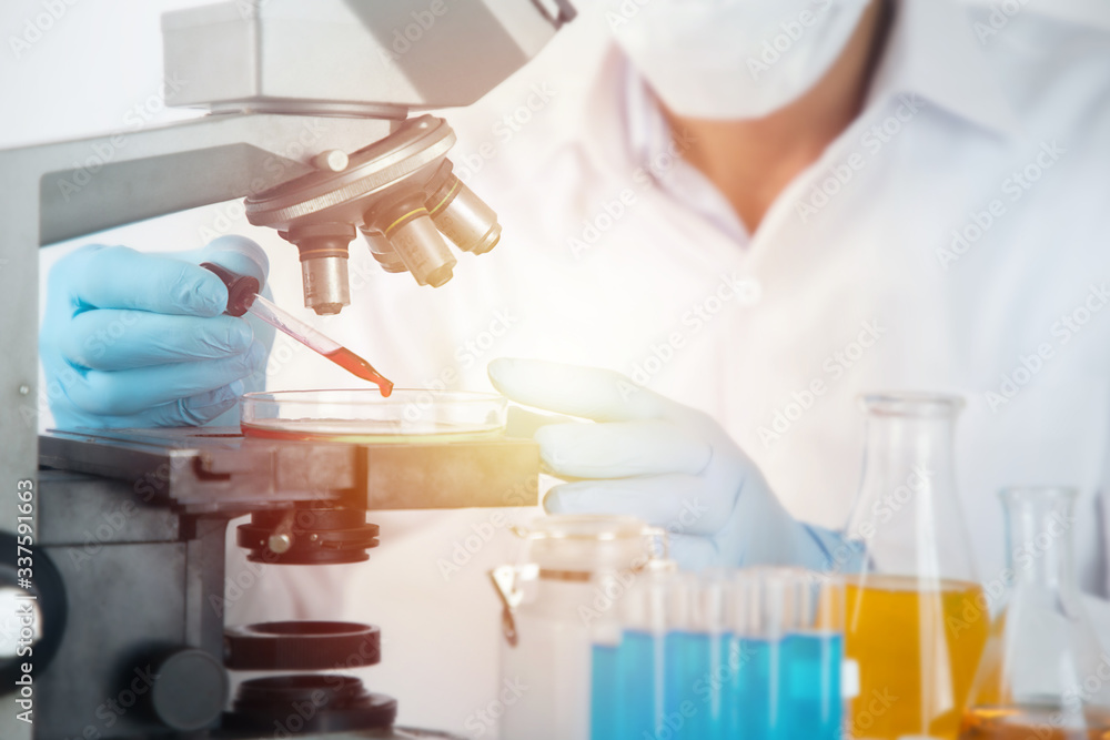 Scientist working with microscope in lab. Laboratory research concept ...