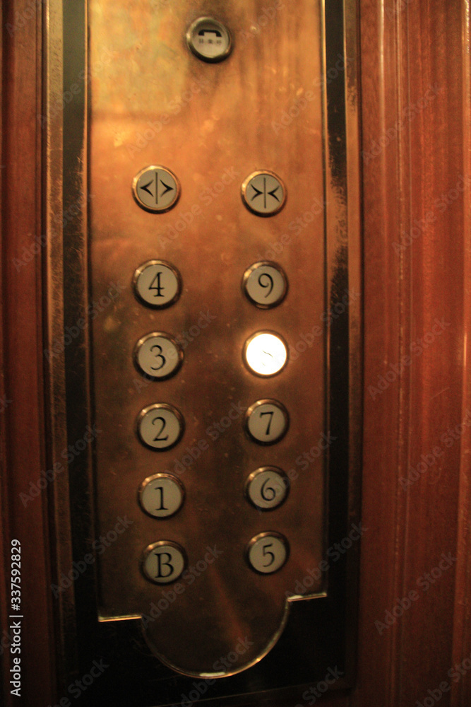 Vintage Wooden Elevator Control Panel Illuminated in Warm Light Stock ...
