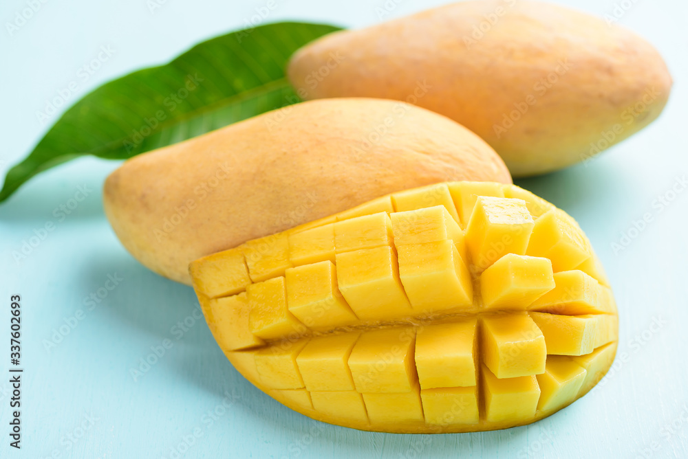 Ripe mango fruit sliced to cubes ready to eating on pastel color ...