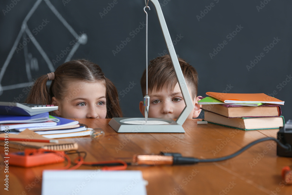 Cute little children at physics lesson in classroom Stock Photo | Adobe ...