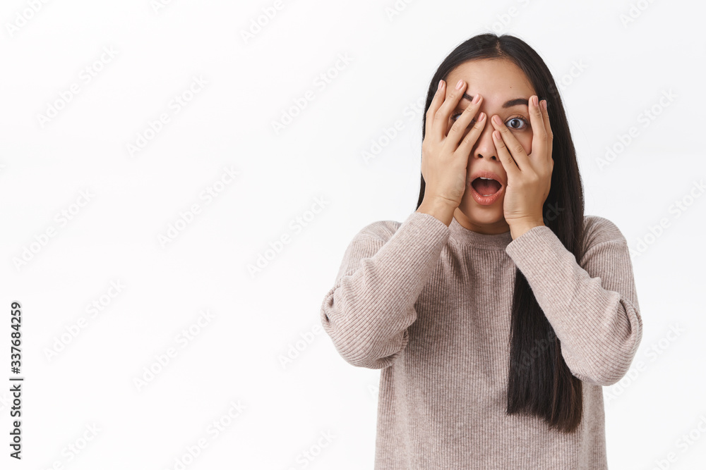Scared embarrassed cute asian girl hiding face, hold hands above eyes ...