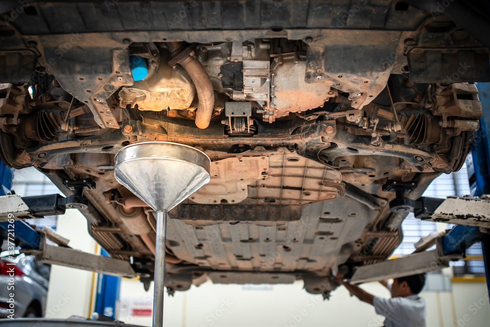 Under-car view that is checking the bottom of the car at the service ...