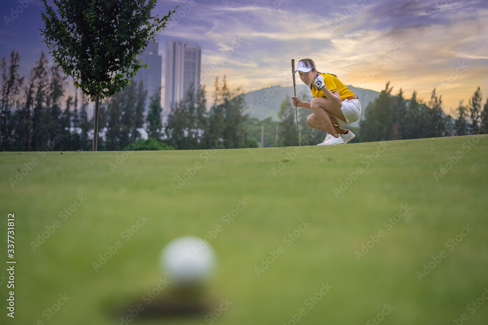 Woman golfer in action of exciting a golf ball runs drop success ...