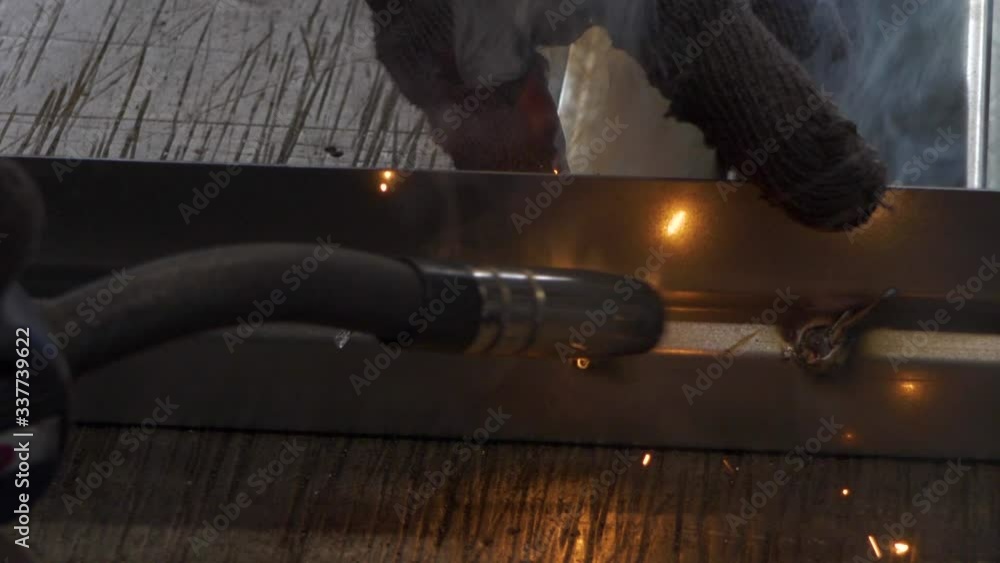 Welder works in metal construction - construction and processing of ...
