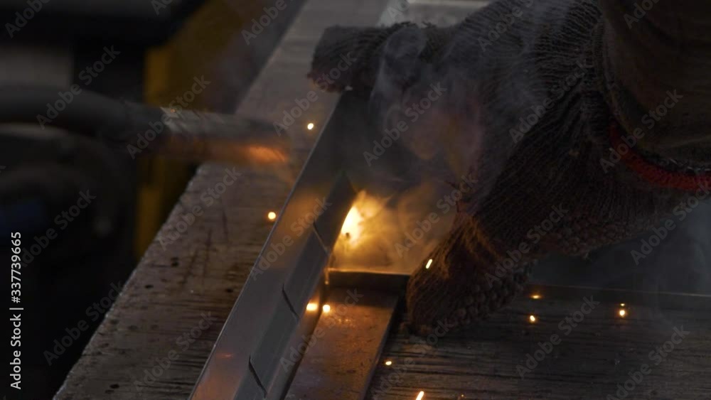 Welder works in metal construction - construction and processing of ...