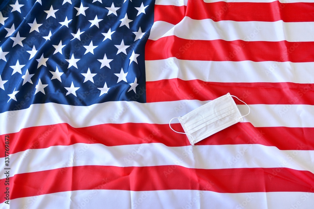 Protective surgical face mask on American national flag. U.S. flag and ...