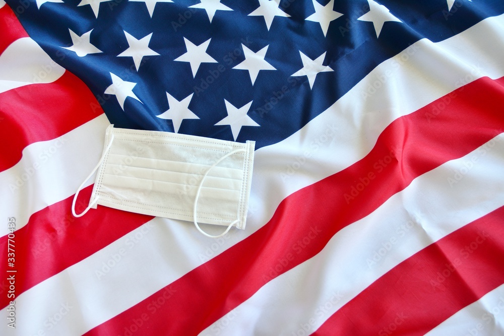 Protective surgical face mask on American national flag. U.S. flag and ...