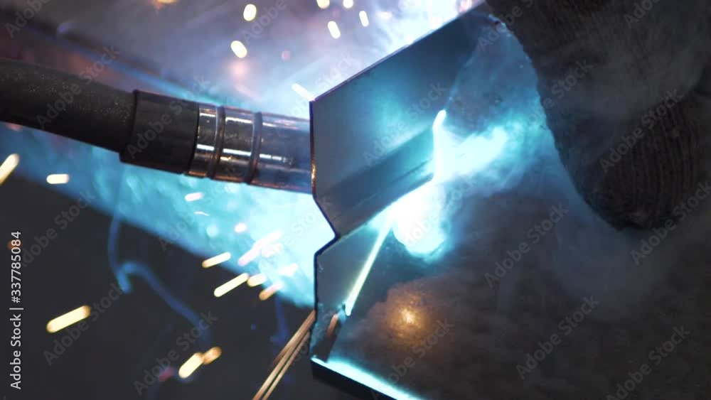 Welder works in metal construction - construction and processing of ...