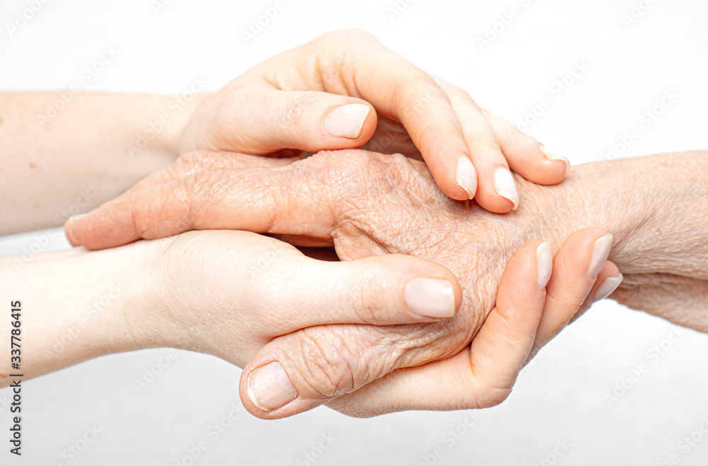 Helping hand for the elderly concept with young hands holding old hand ...