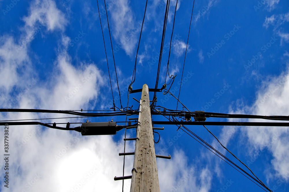 View up Old Style telephone pole with utility lines. The communication ...