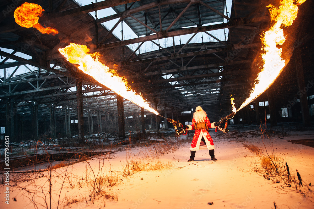 Santa Claus with flamethrowers in an abandoned warehouse Stock Photo ...