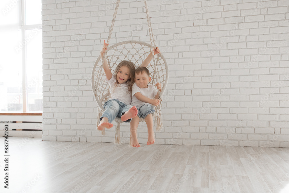 little children sit in a circular rope swing Stock Photo | Adobe Stock
