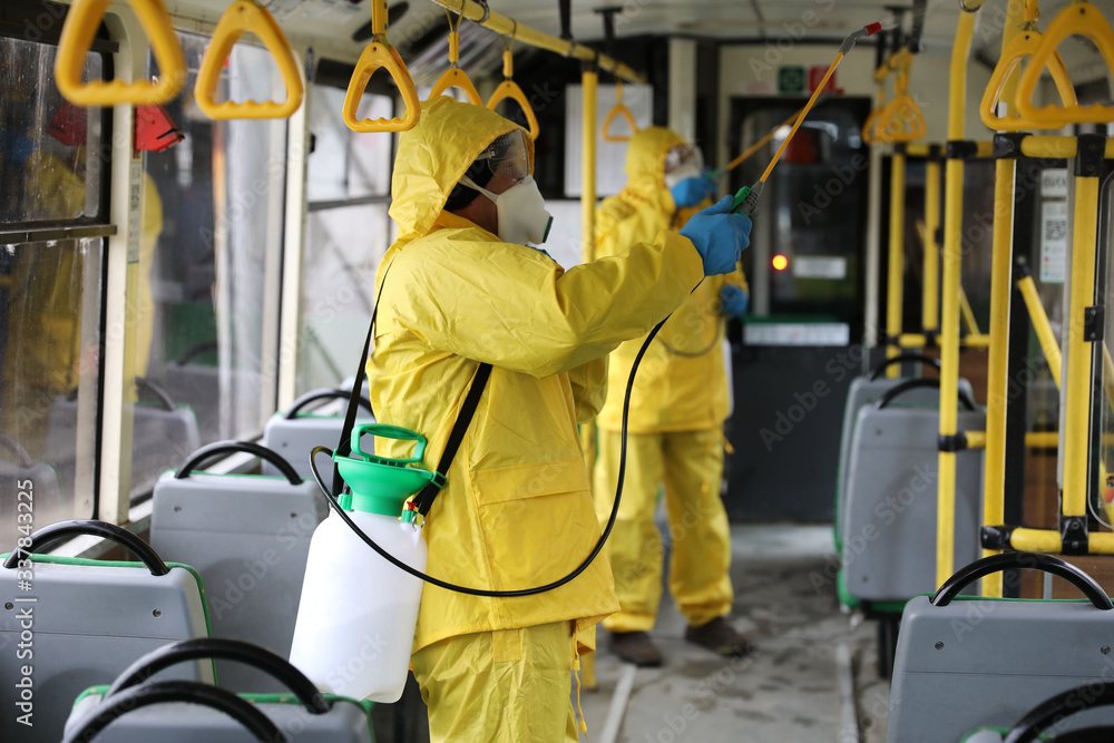 Workers disinfecting bus at bus depot. Lviv, Ukraine. Stock Photo ...