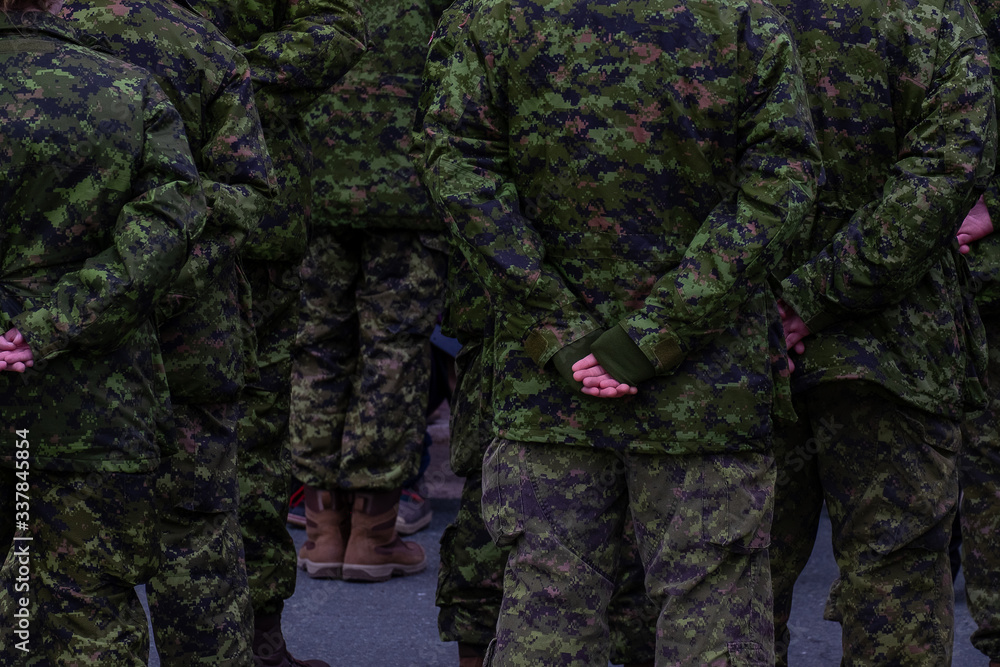 Military men standing in formation on parade wearing green camouflage ...