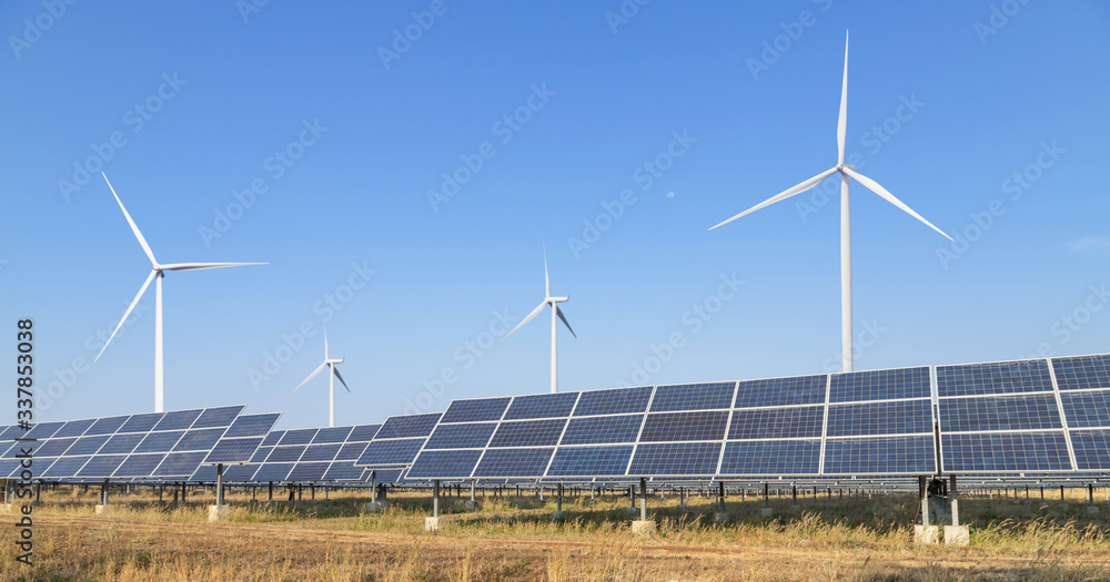 Solar panels and wind turbines generating electricity is solar energy ...