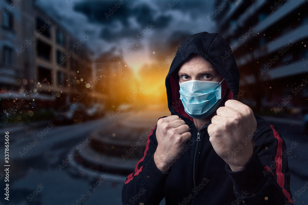 Fighting coronavirus concept: a cloaked man wearing a surgical ...