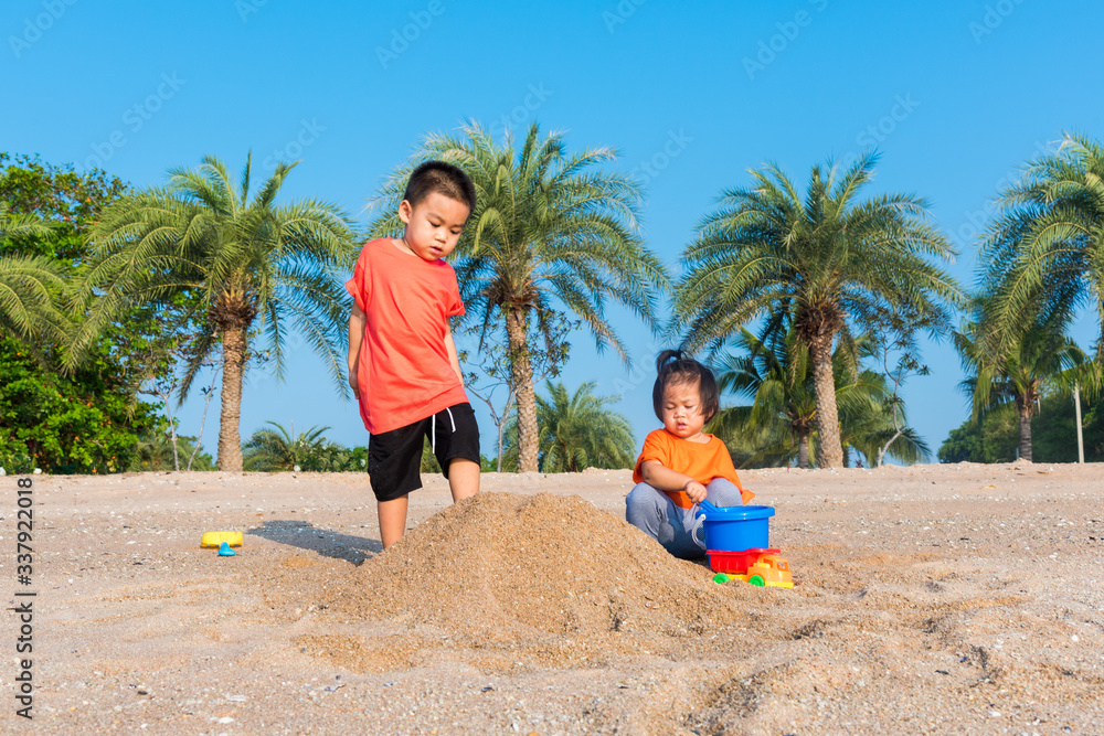 Brother and sister two children funny digging play toy with sand Stock ...