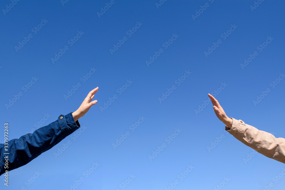 Two hands in a welcome gesture. Dark and light sleeve of clothes ...