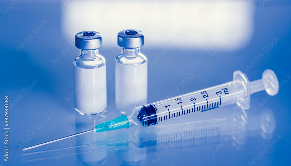 Vaccine vial dose flu shot drug needle syringe,medical concept . blue ...