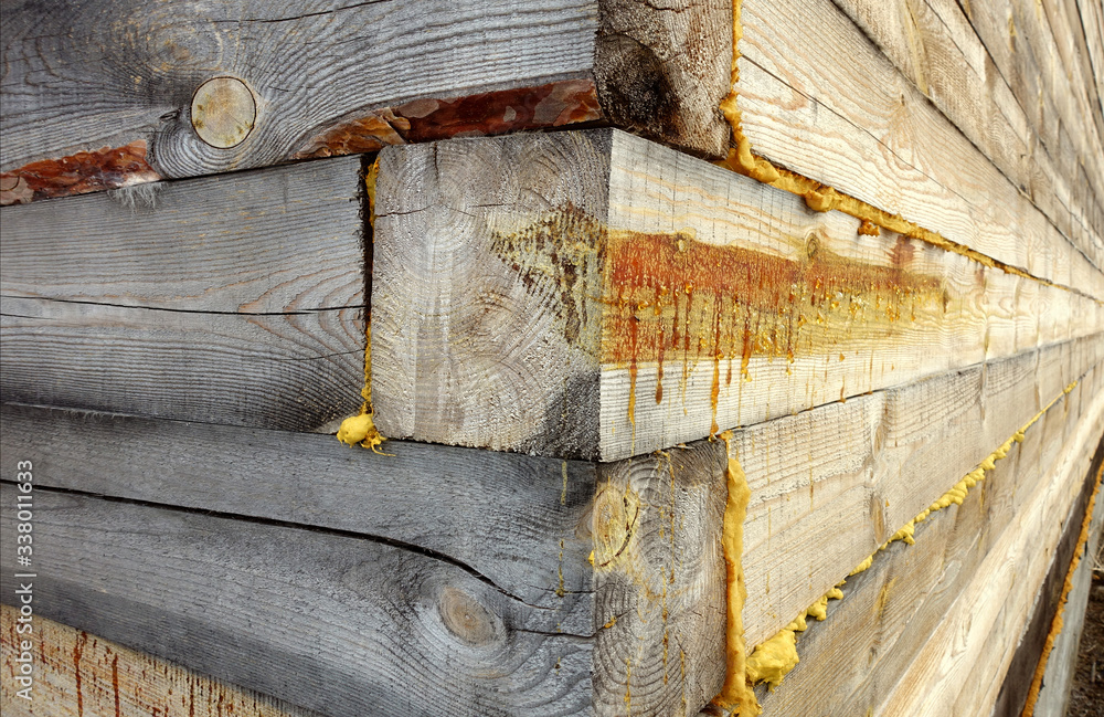 Corner of a log house close-up. Wooden structure, the joints of the ...