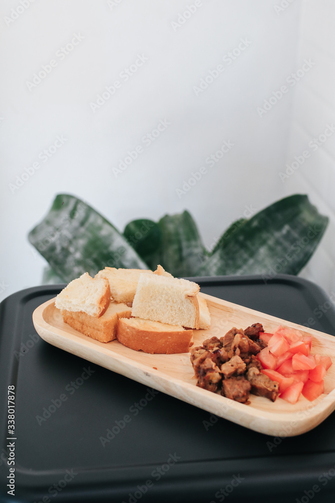 Close-up many pieces of crispy bread toast with roast dice pork and ...