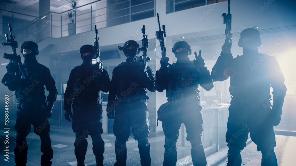 Masked Team of Armed SWAT Police Officers with Rifles are Posing After ...