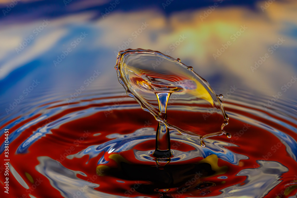 water drop collision of two drops with colorful reflection of ...