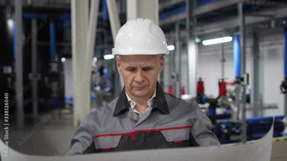 Portrait of male worker engineer man with drawing design in hard hat ...