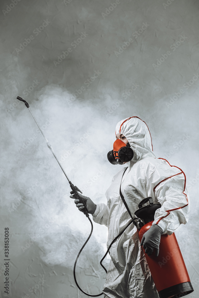 professional disinfector fully armed with necessary equipment, ready to ...