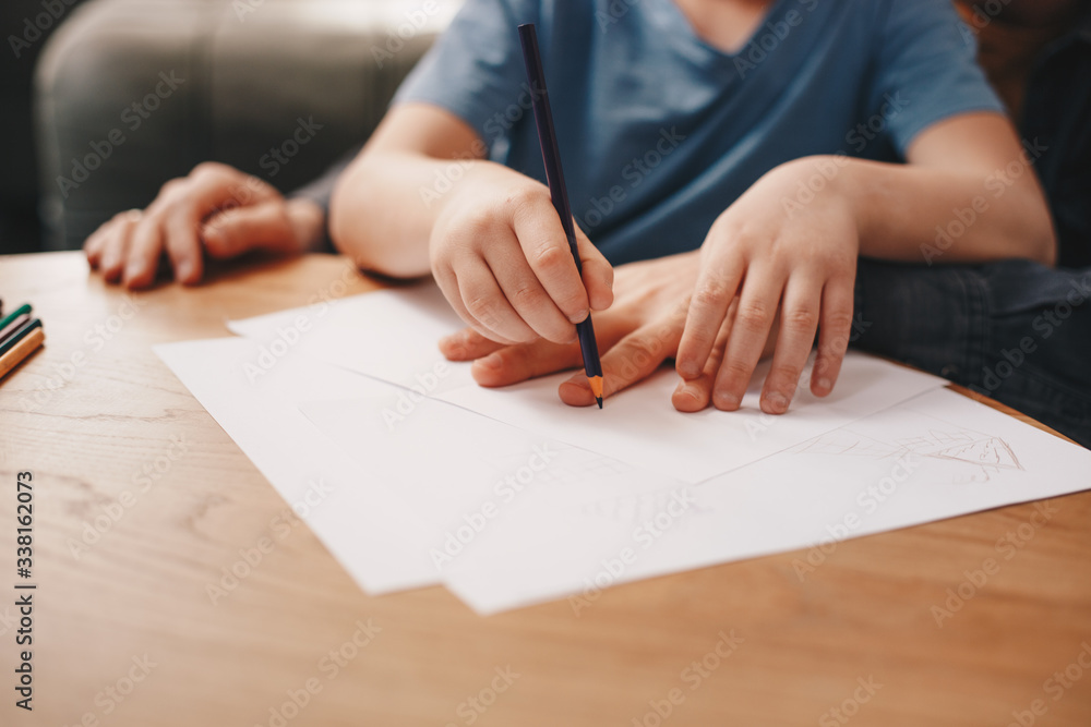 Cute boy and his father coloring pictures with crayons Stock Photo ...